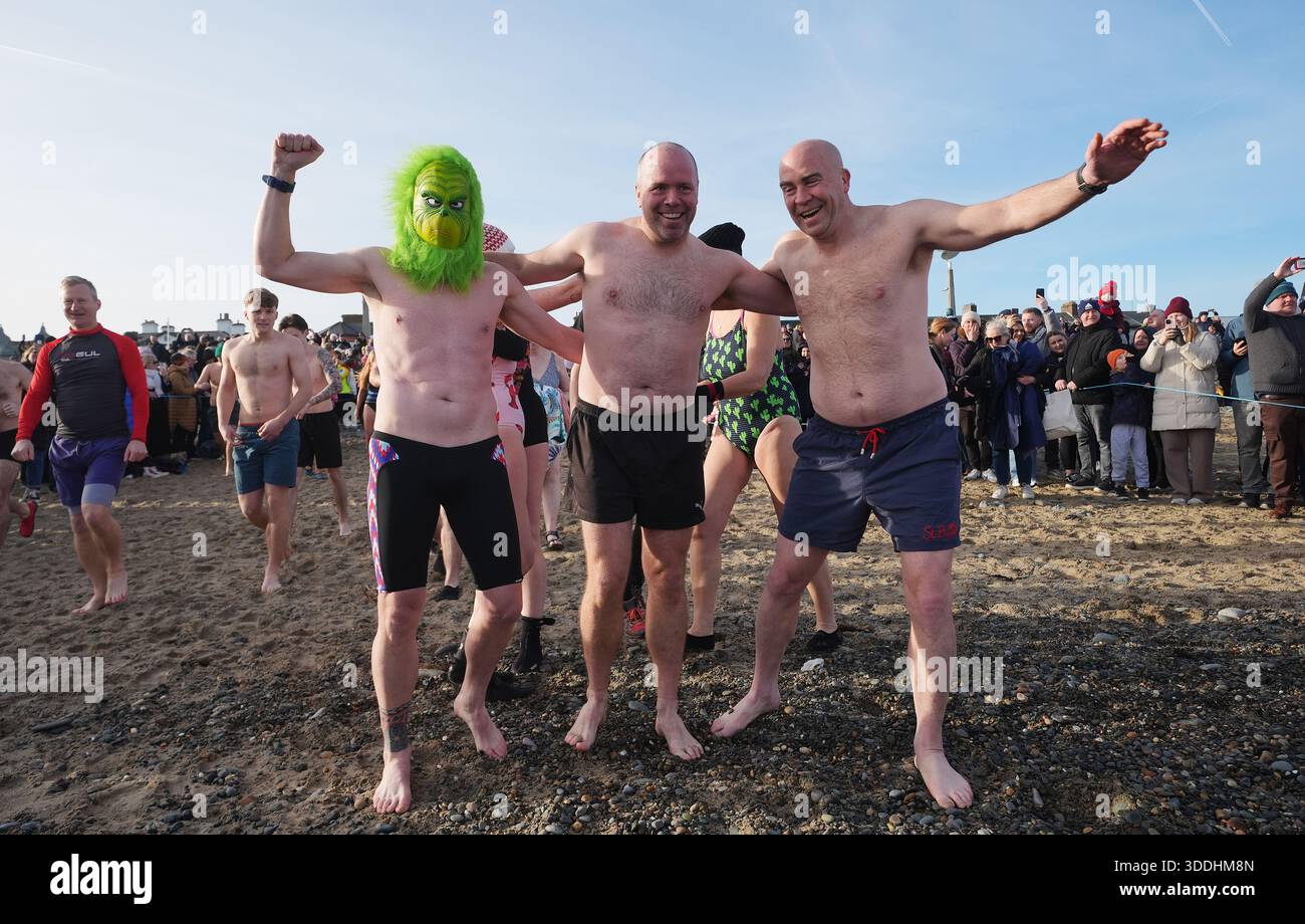 Swimmers take part in the annual New Year’s Day charity swim on Bray ...