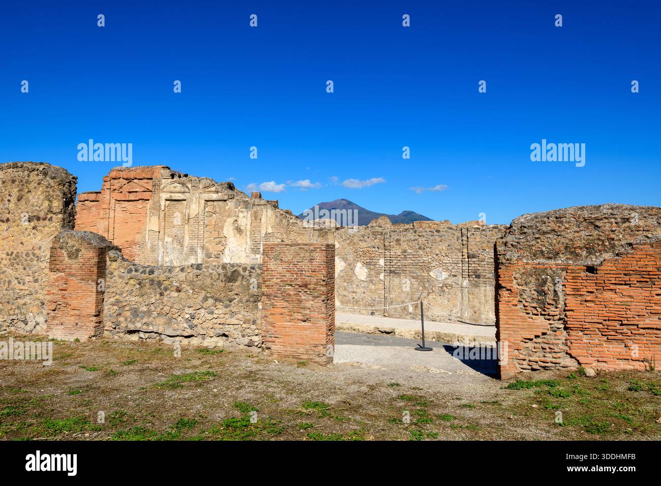 Weathered stone and brick walls of the Comitium in Pompeii, Italy stand ...