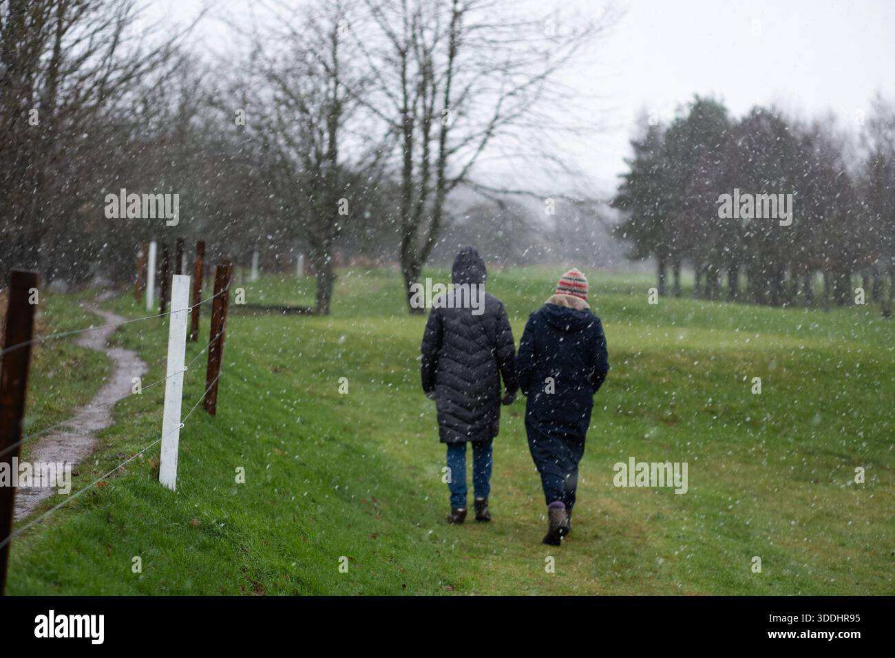 Walkers out in the snow in Cults Aberdeen, Scotland on new Years Day ...