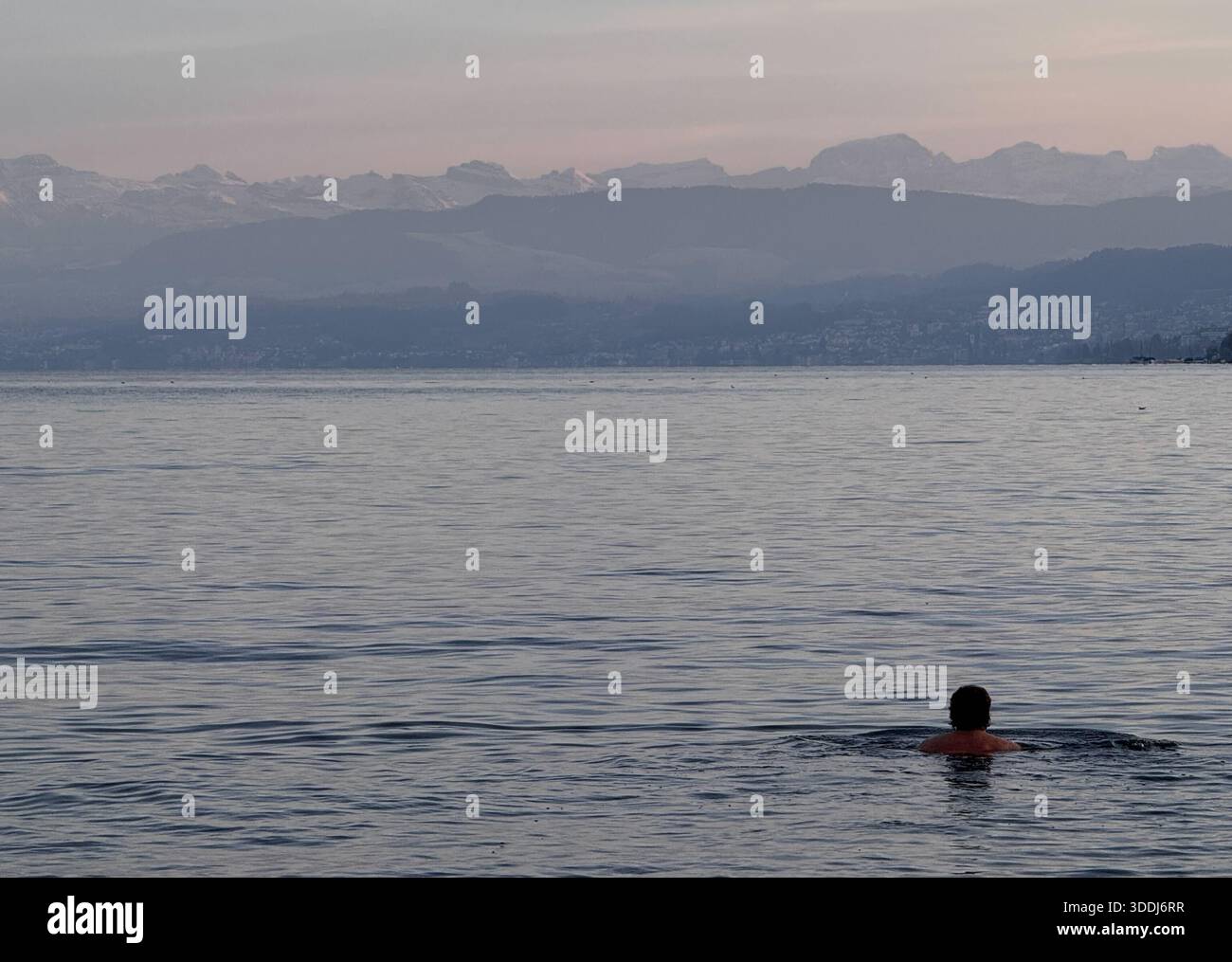 01 January 2026, Switzerland, Zürich: A man goes swimming in Lake ...