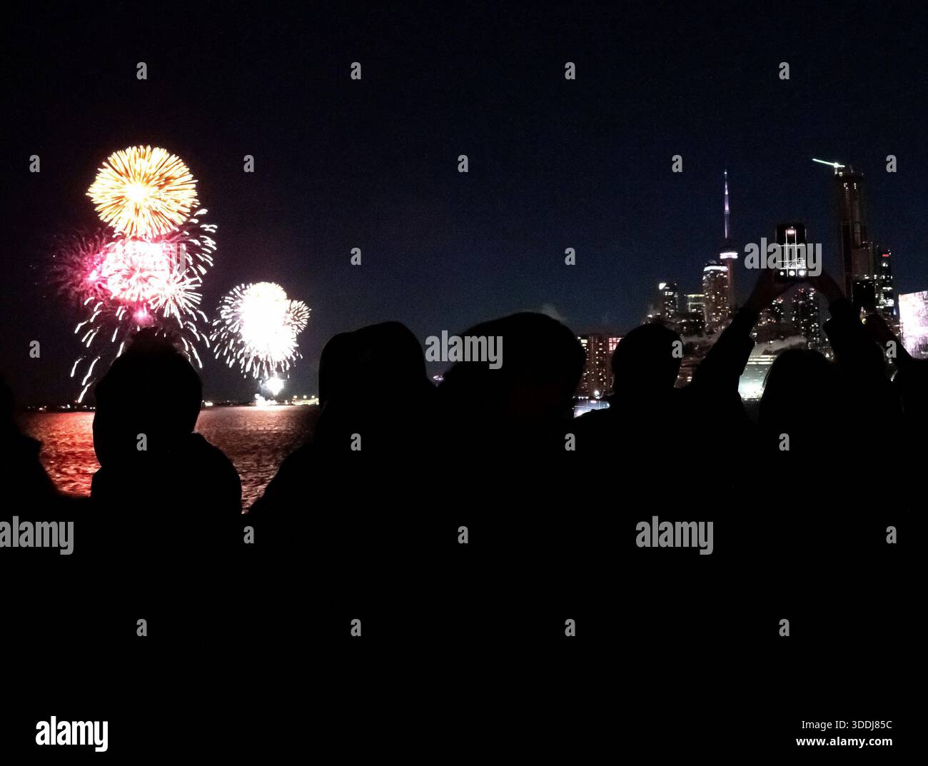 Revellers watch as fireworks light up Toronto's inner harbour to ring ...