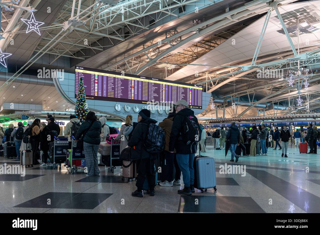 Security officers screen passengers as belongings pass through the X ...