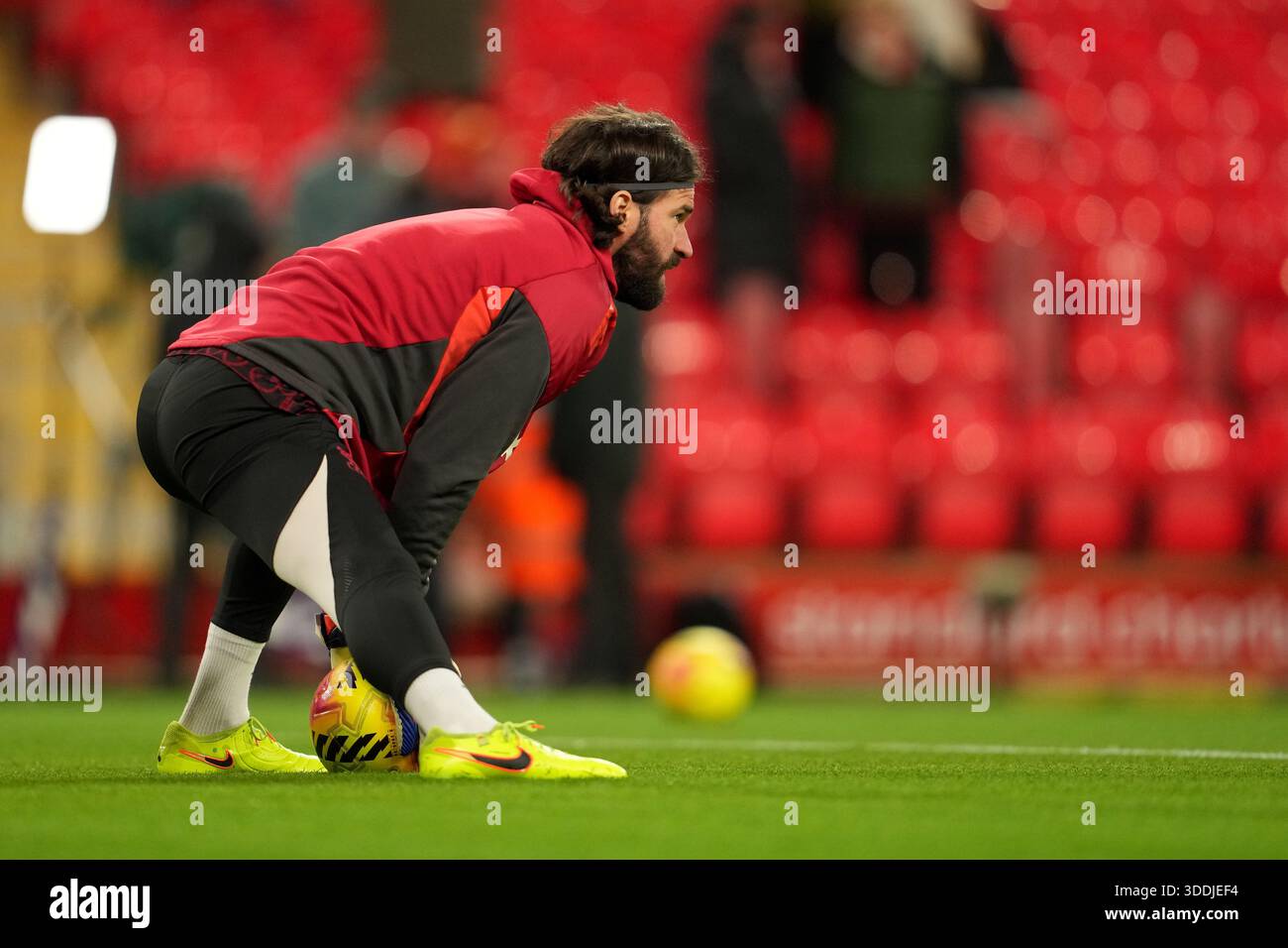 Liverpool's goalkeeper Alisson stretches himself during warm up before ...