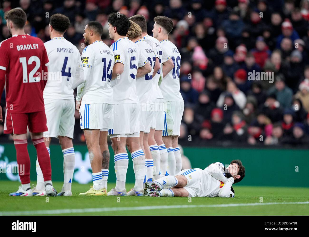 Leeds United's Brenden Aaronson lies down behind the wall during the ...