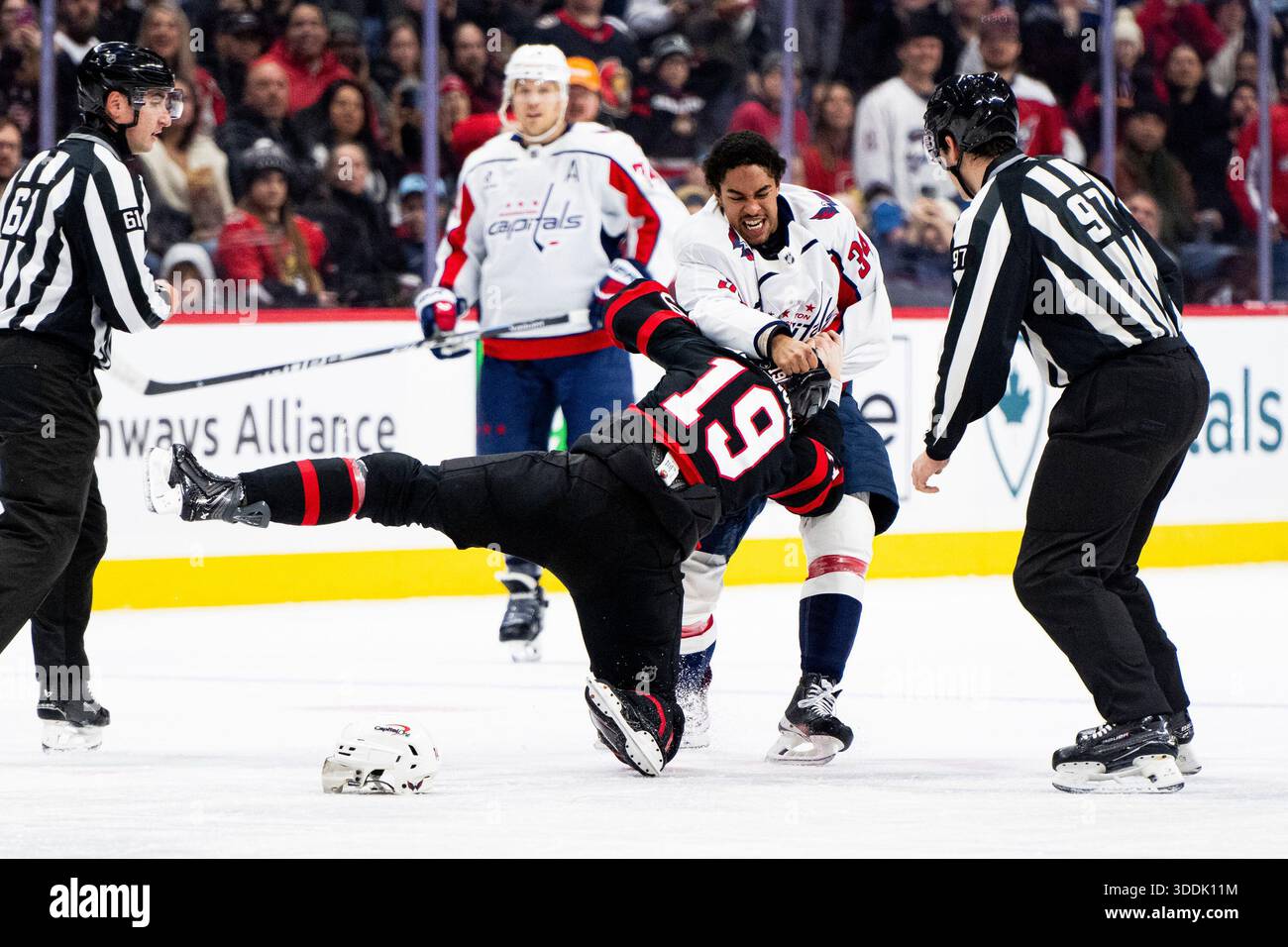 Washington Capitals' Justin Sourdif (34) knocks down Ottawa Senators ...