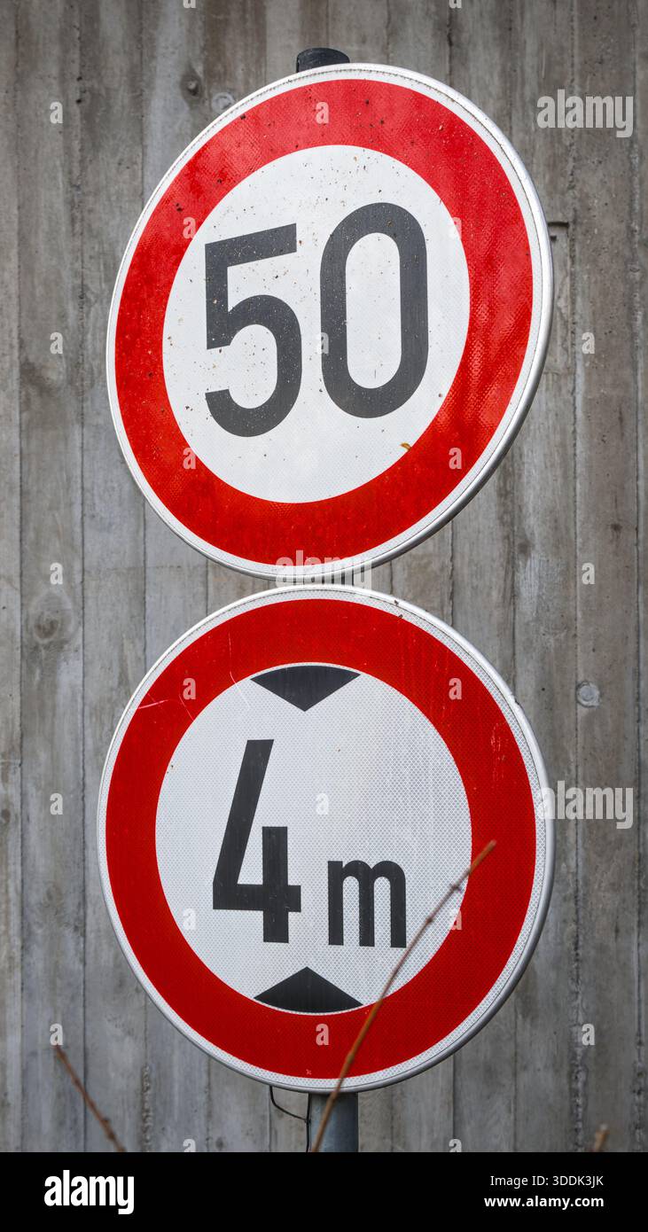 Two round traffic signs display speed and height limits in front of a ...