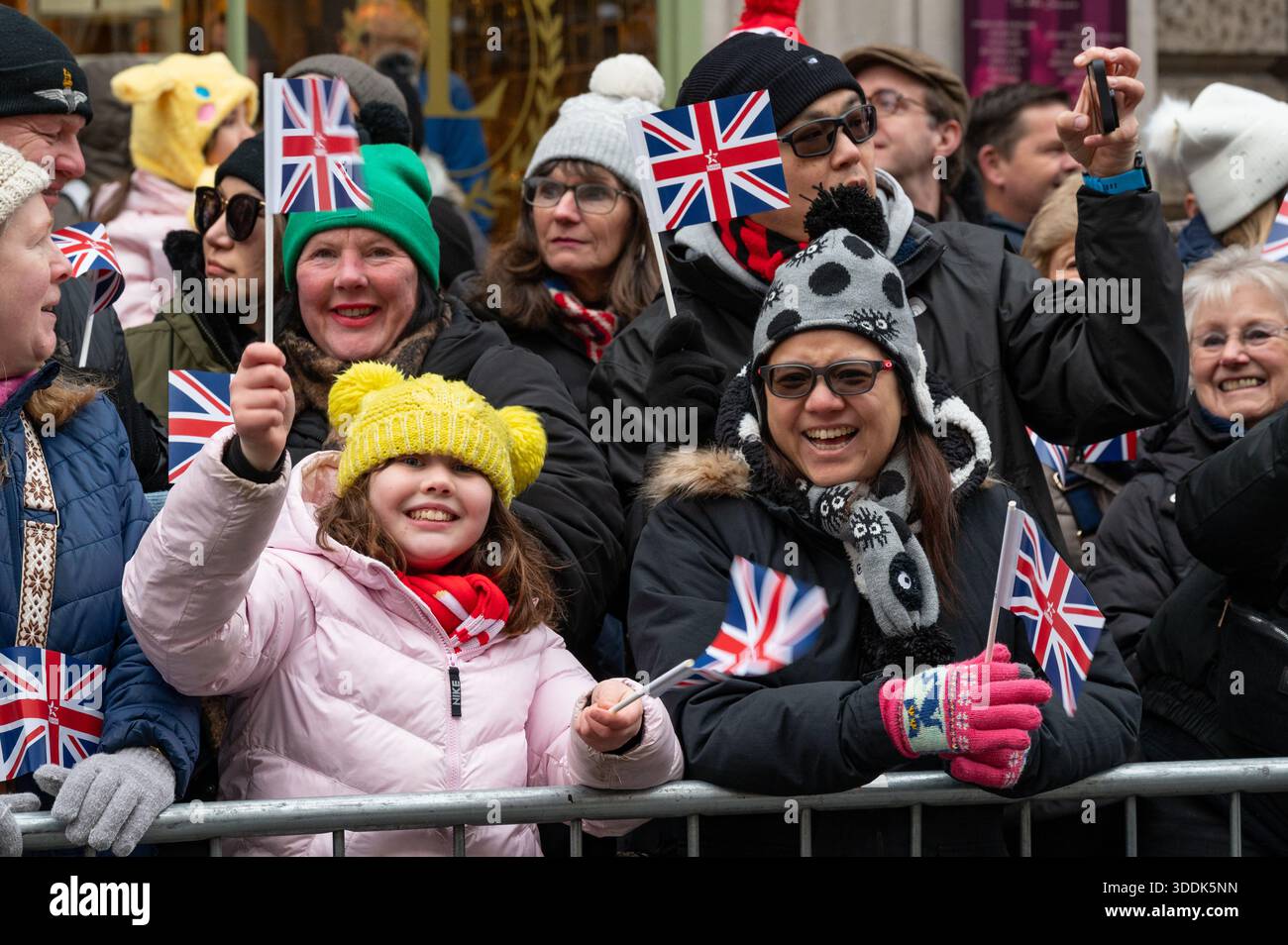Bystanders cheers with union Jack flags during the parade. Performers ...