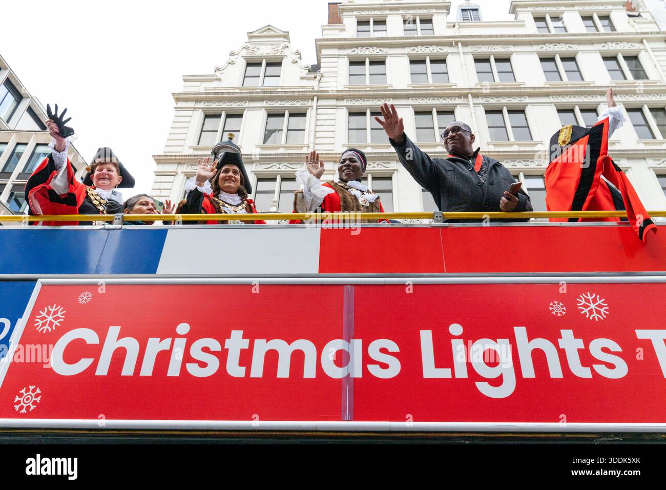 People on top of a double-decker bus during the parade. Performers ...