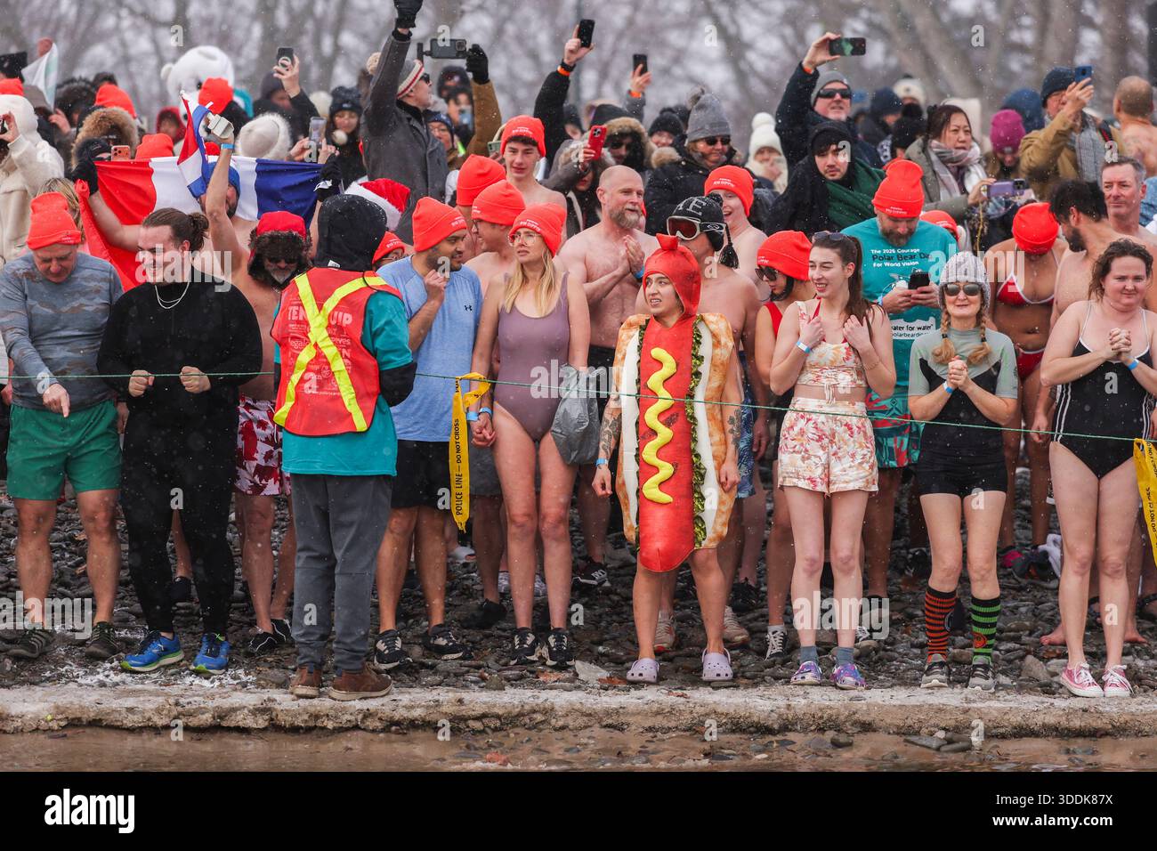 People wait to enter the water during the annual polar bear dip on New ...