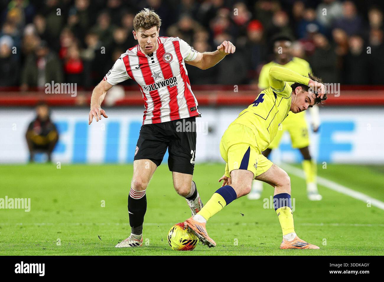 Archie Gray of Tottenham Hotspur challenges Nathan Collins of Brentford ...
