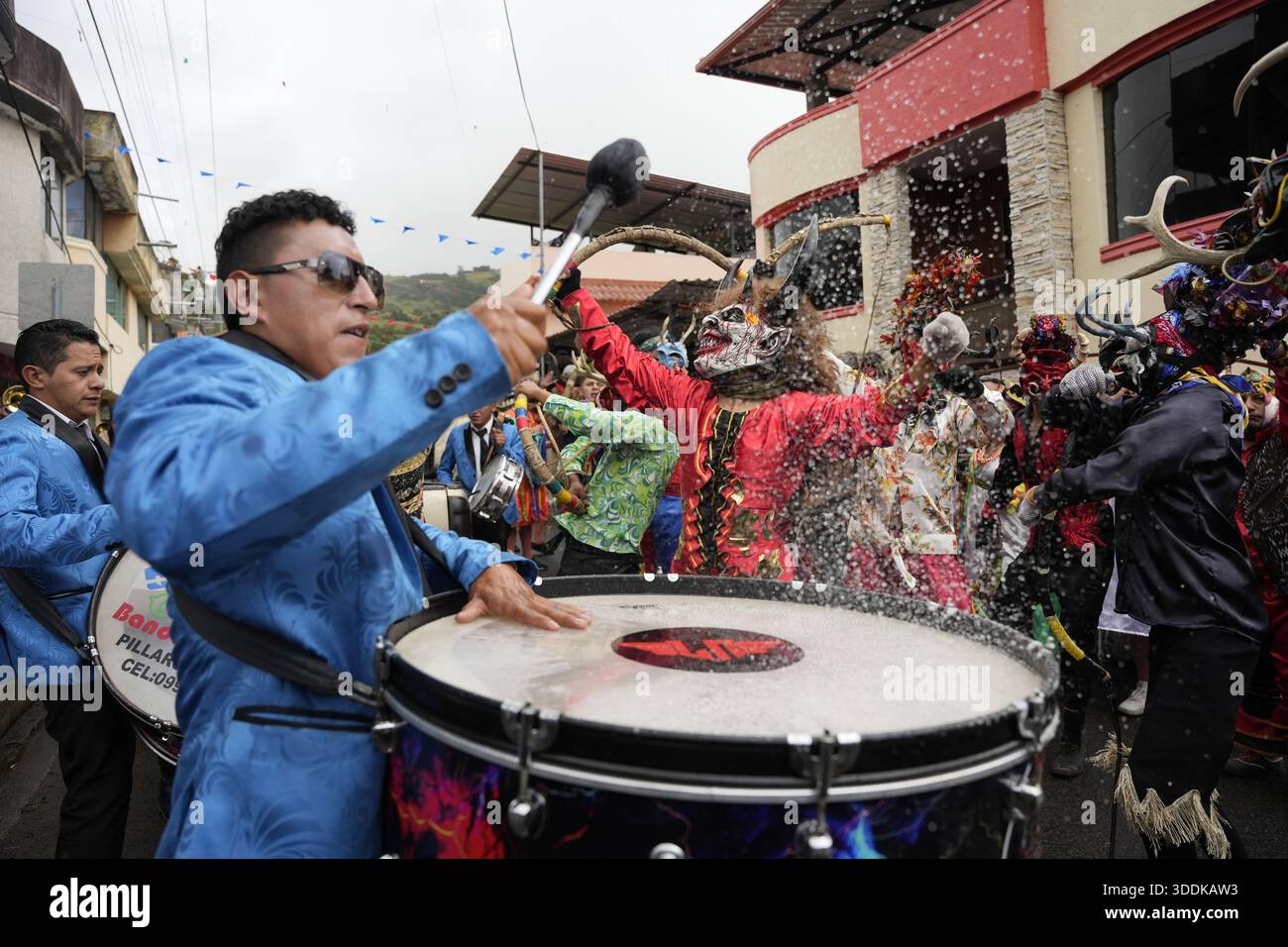 Musicians play and revelers in devil masks dance during traditional New ...