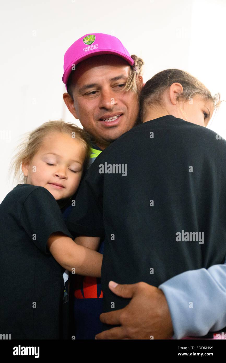 Australian cricketer Usman Khawaja hugs his children Ayla and Aisha ...