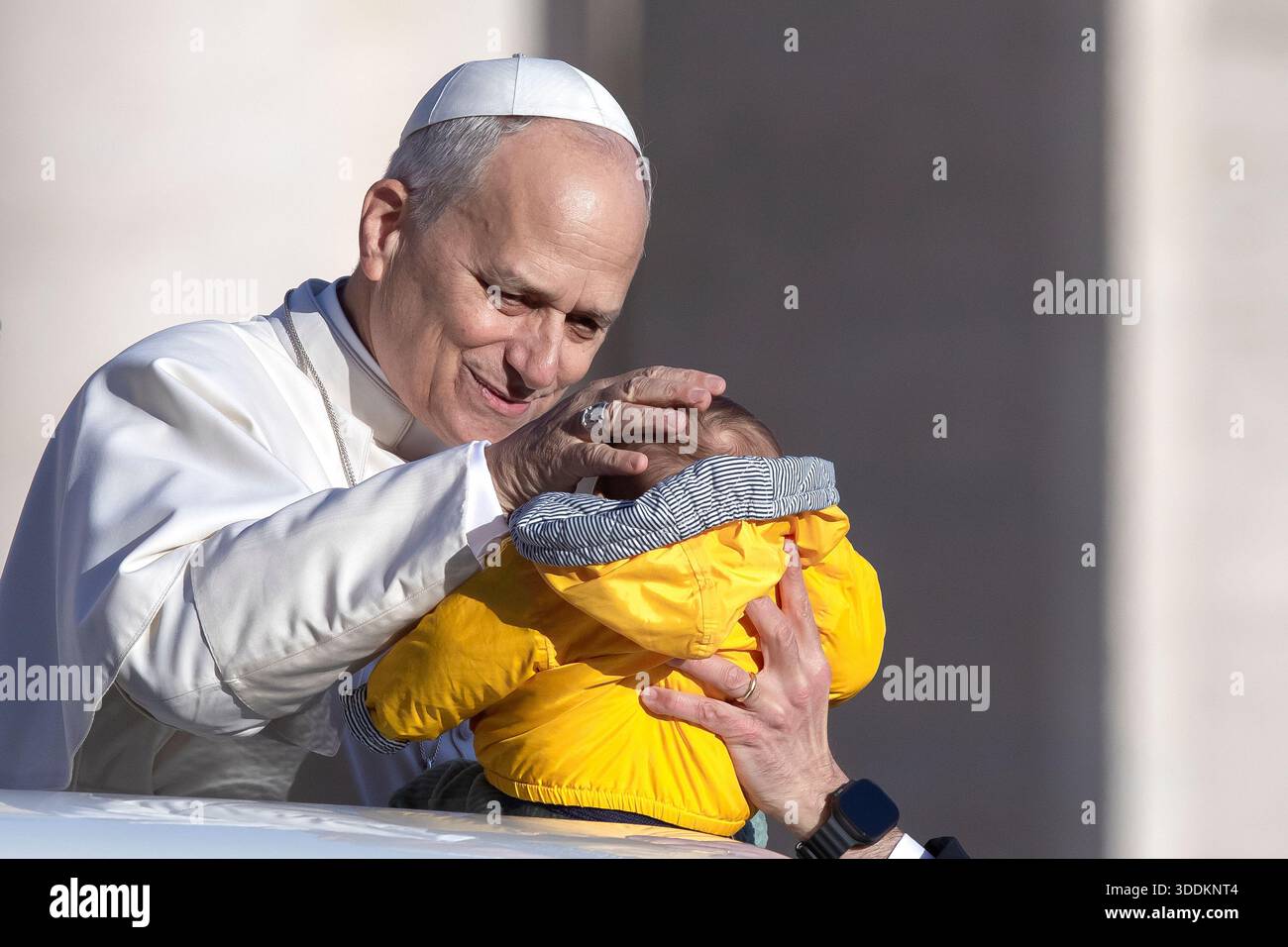Pope Leo XIV greets a child as he arrives for his weekly general ...