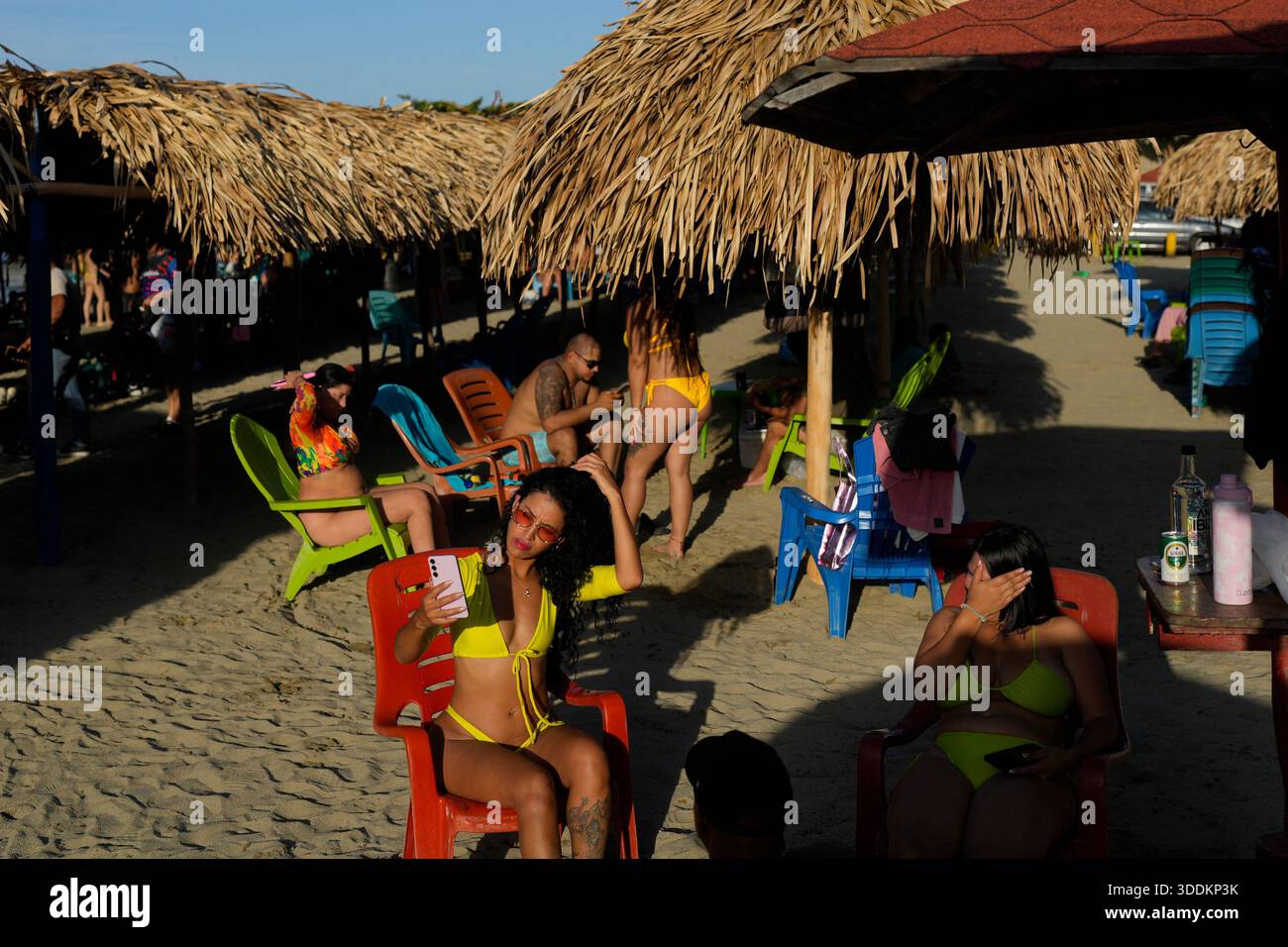 A woman takes a selfie on the shore of a beach in La Guaira, Venezuela ...