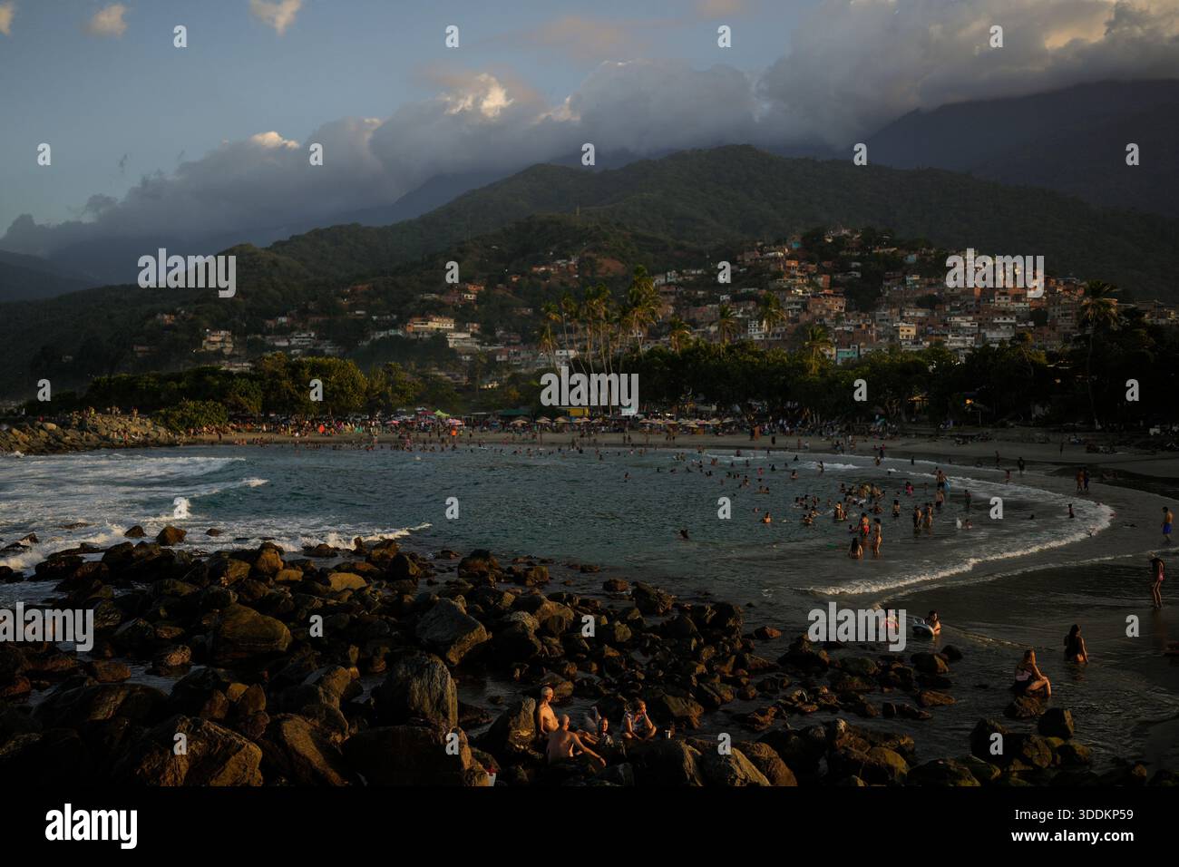 People gather on the shore of a beach in La Guaira, Venezuela, Thursday ...