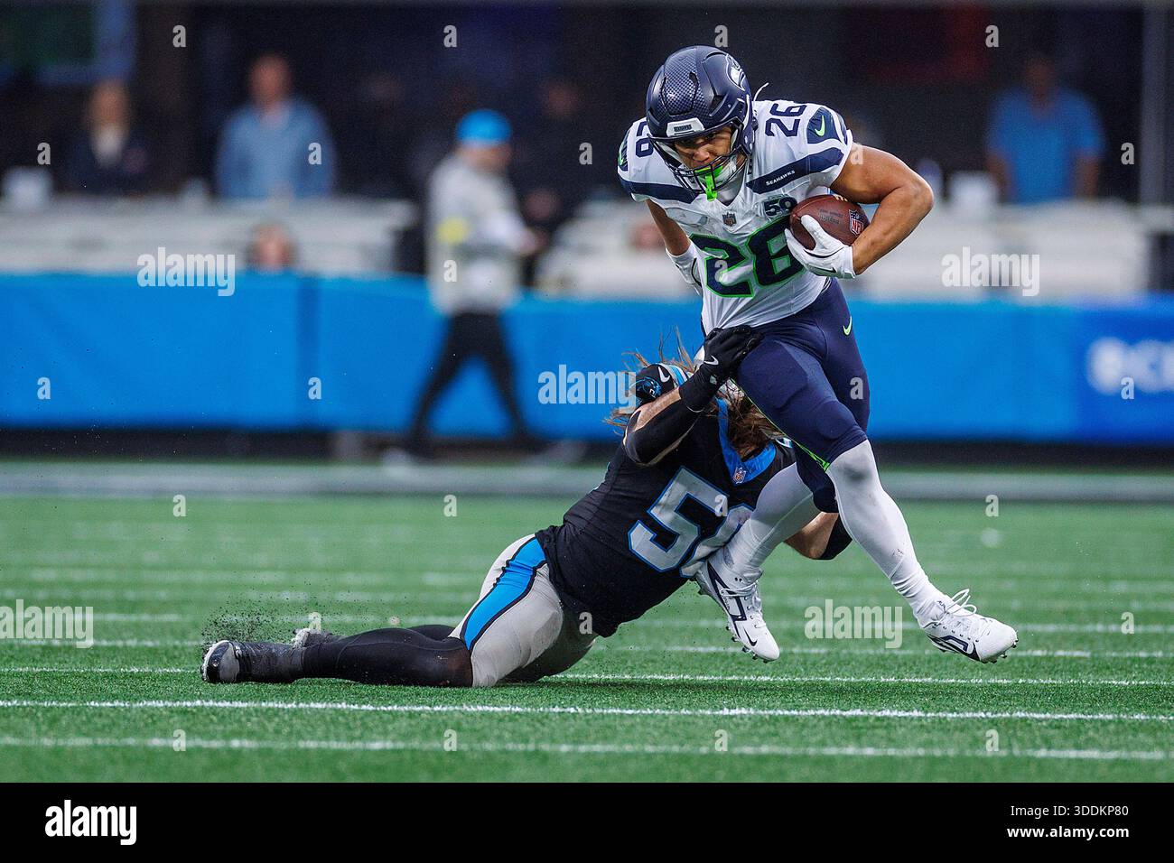 Seattle Seahawks running back Zach Charbonnet (26) attempts to shake ...