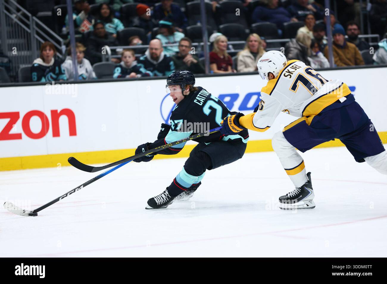 Seattle Kraken center Berkly Catton (27) moves the puck while defended ...