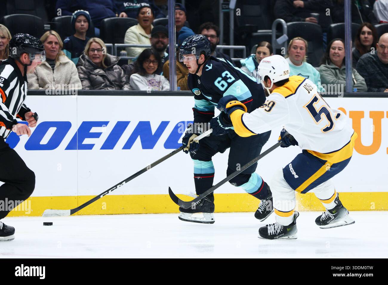 Seattle Kraken right wing Jacob Melanson (63) moves the puck while ...