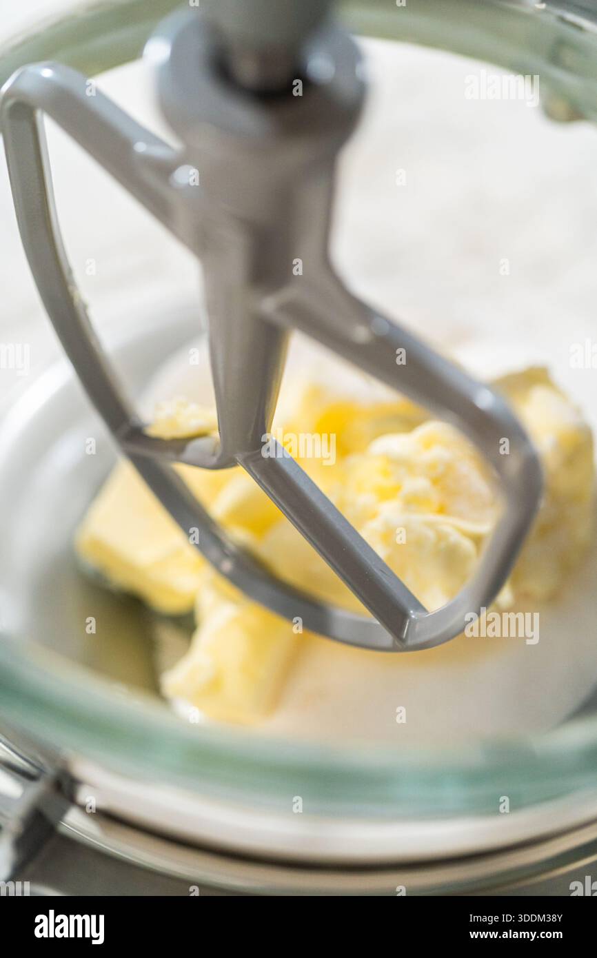 Close-up of a stand mixer creaming together butter and sugar for the ...