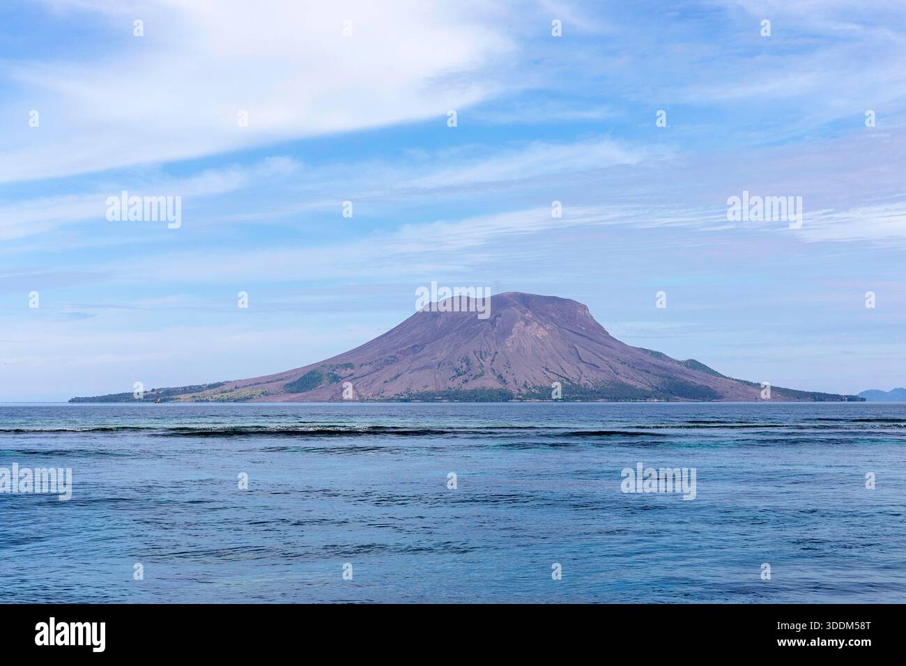 Dangerous Ruang island with A-type cone volcano, that rises from the ...