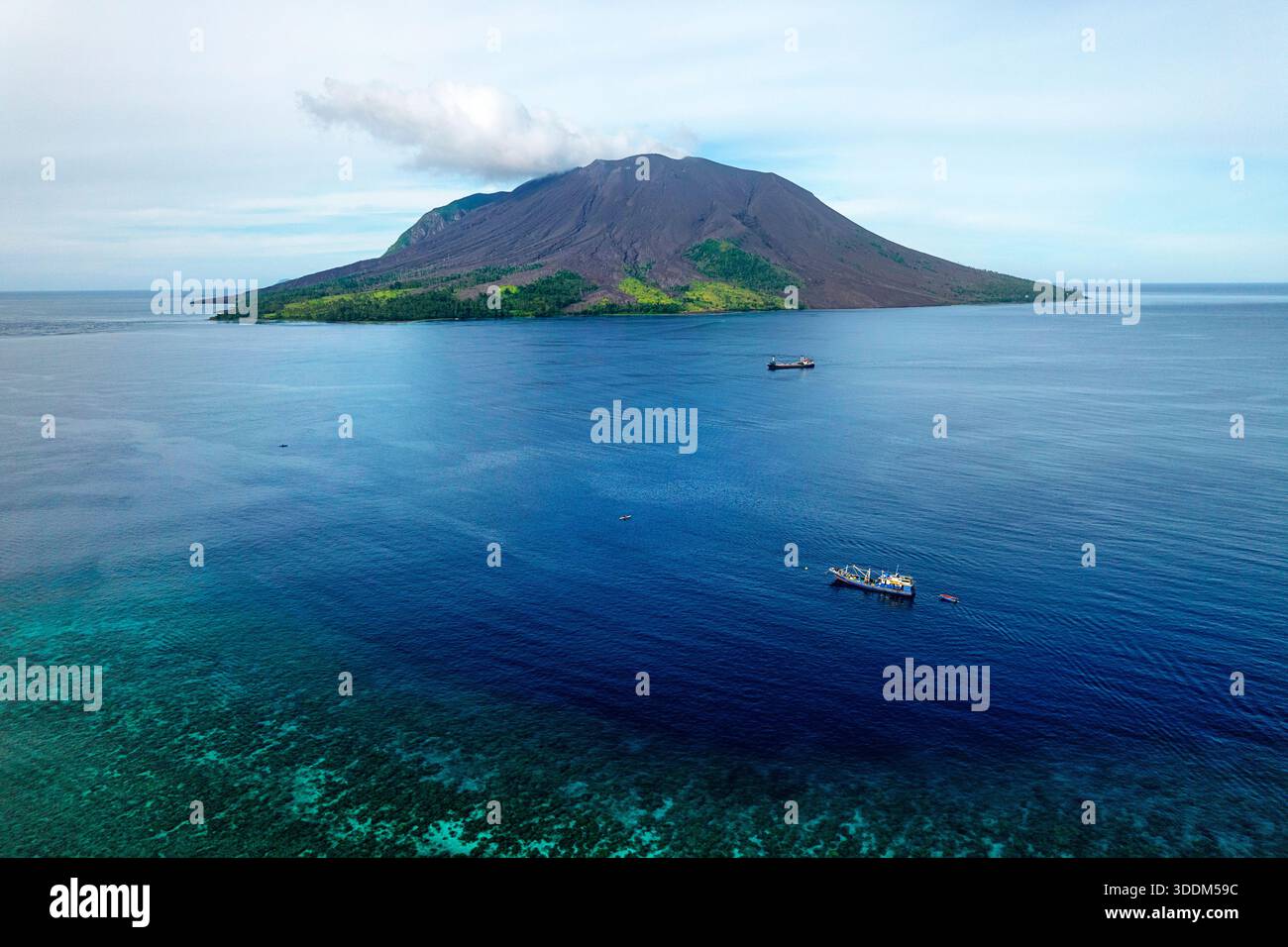 Dangerous Ruang island with A-type cone volcano, that rises from the ...