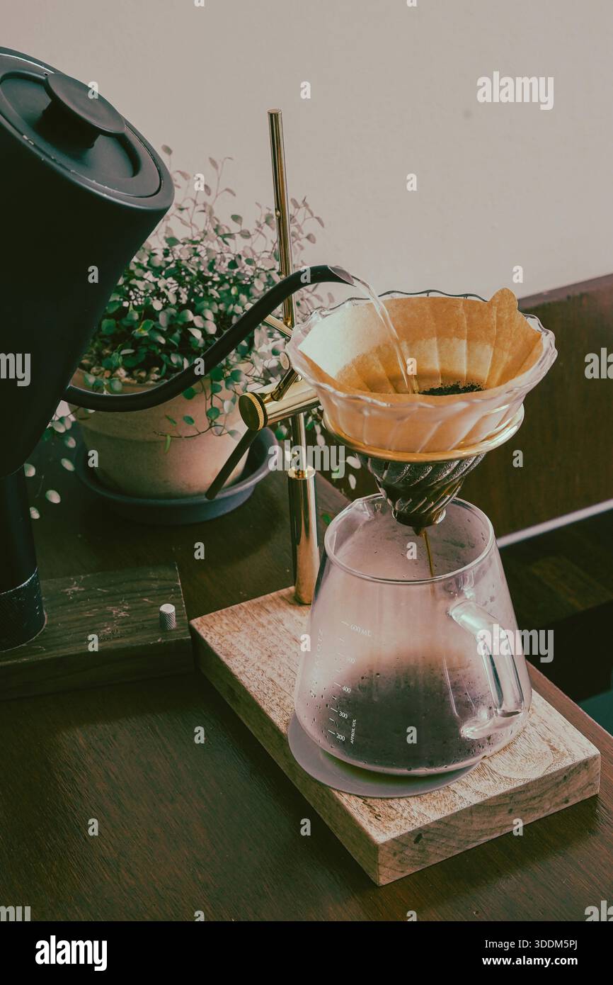 Hand pouring water from kettle hi-res stock photography and images - Alamy