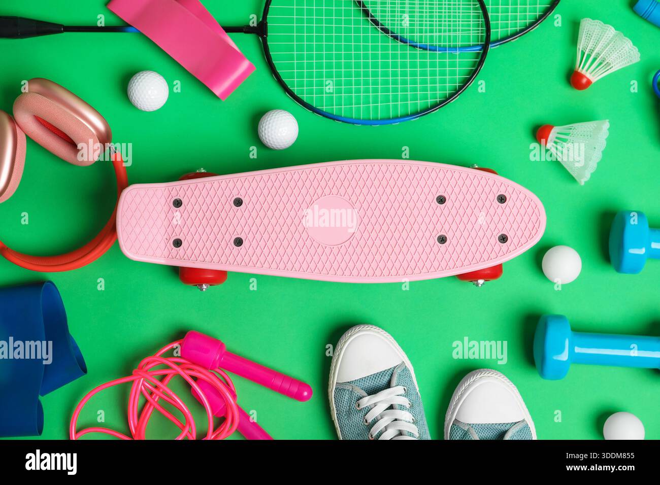 Penny board, sneakers and sports equipment on green background, flat ...