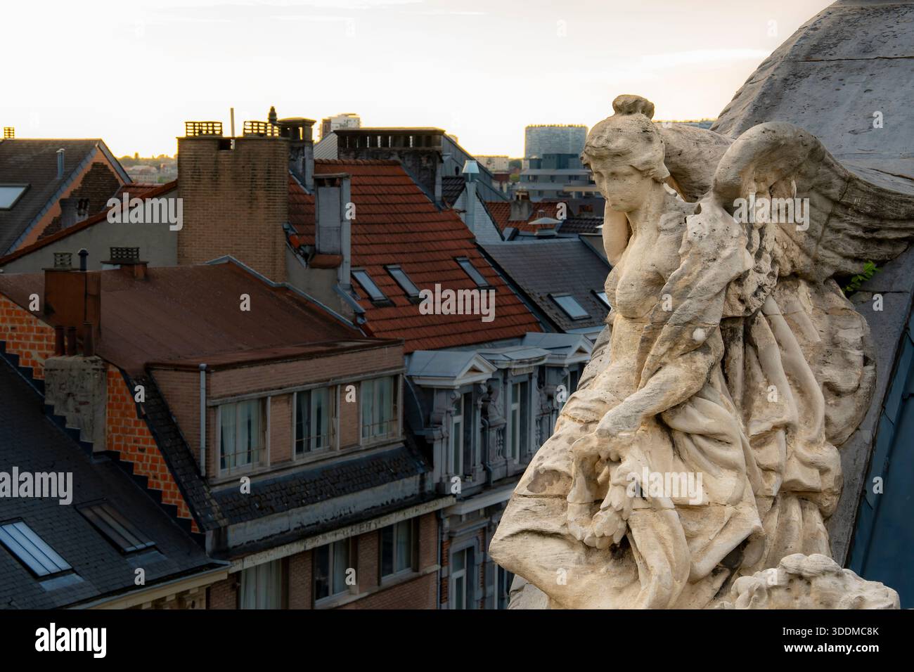 A stone carved angel sits above the parapet atop the old Stock Exchange ...