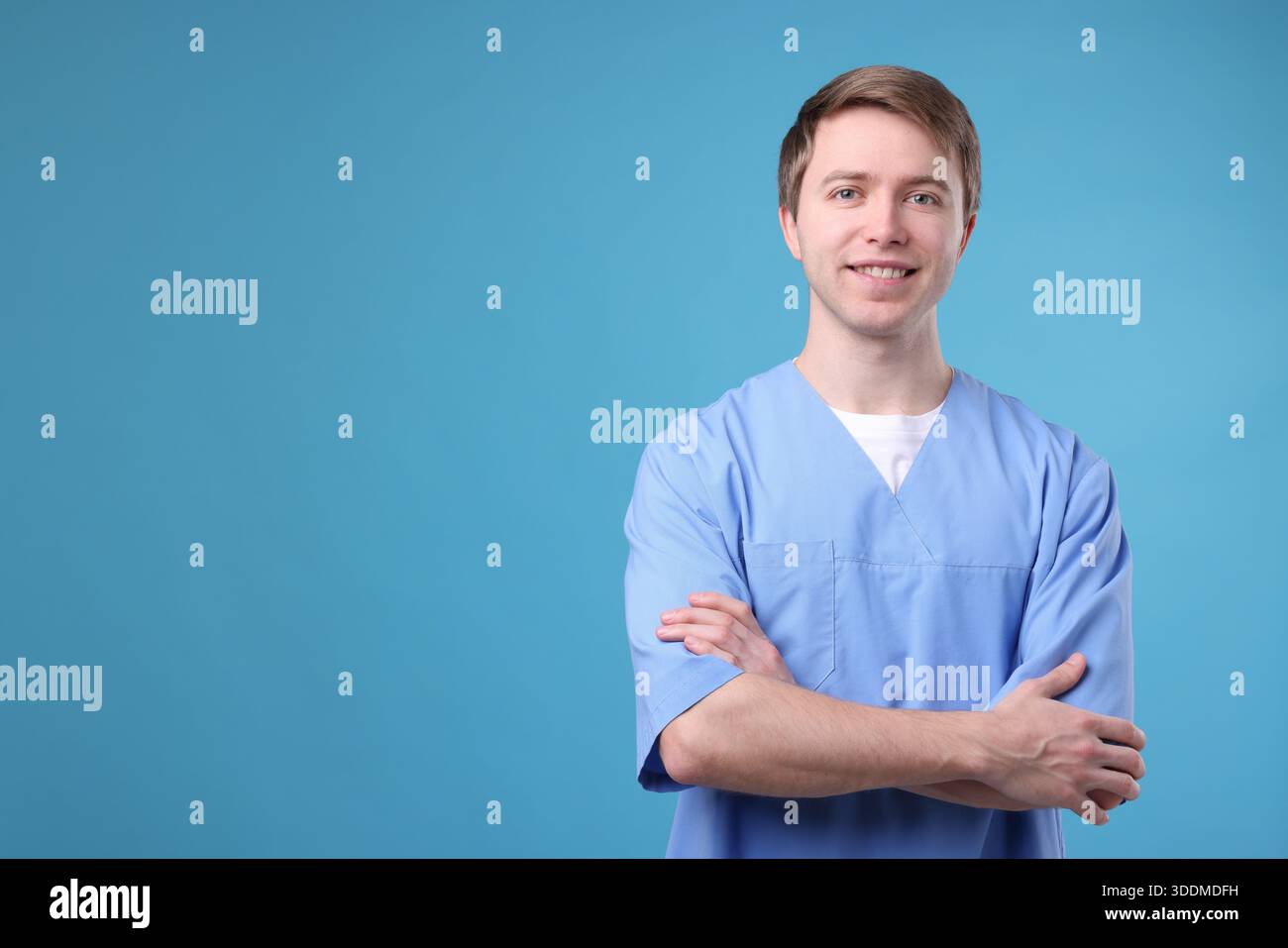 Portrait of medical assistant on light blue background, space for text ...