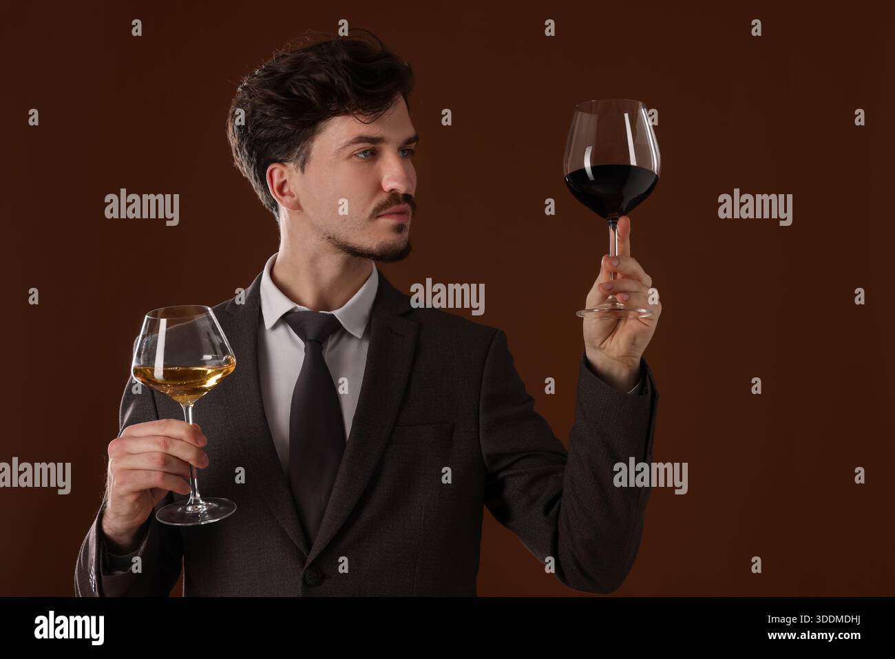 Professional sommelier with glasses of wine on brown background Stock ...