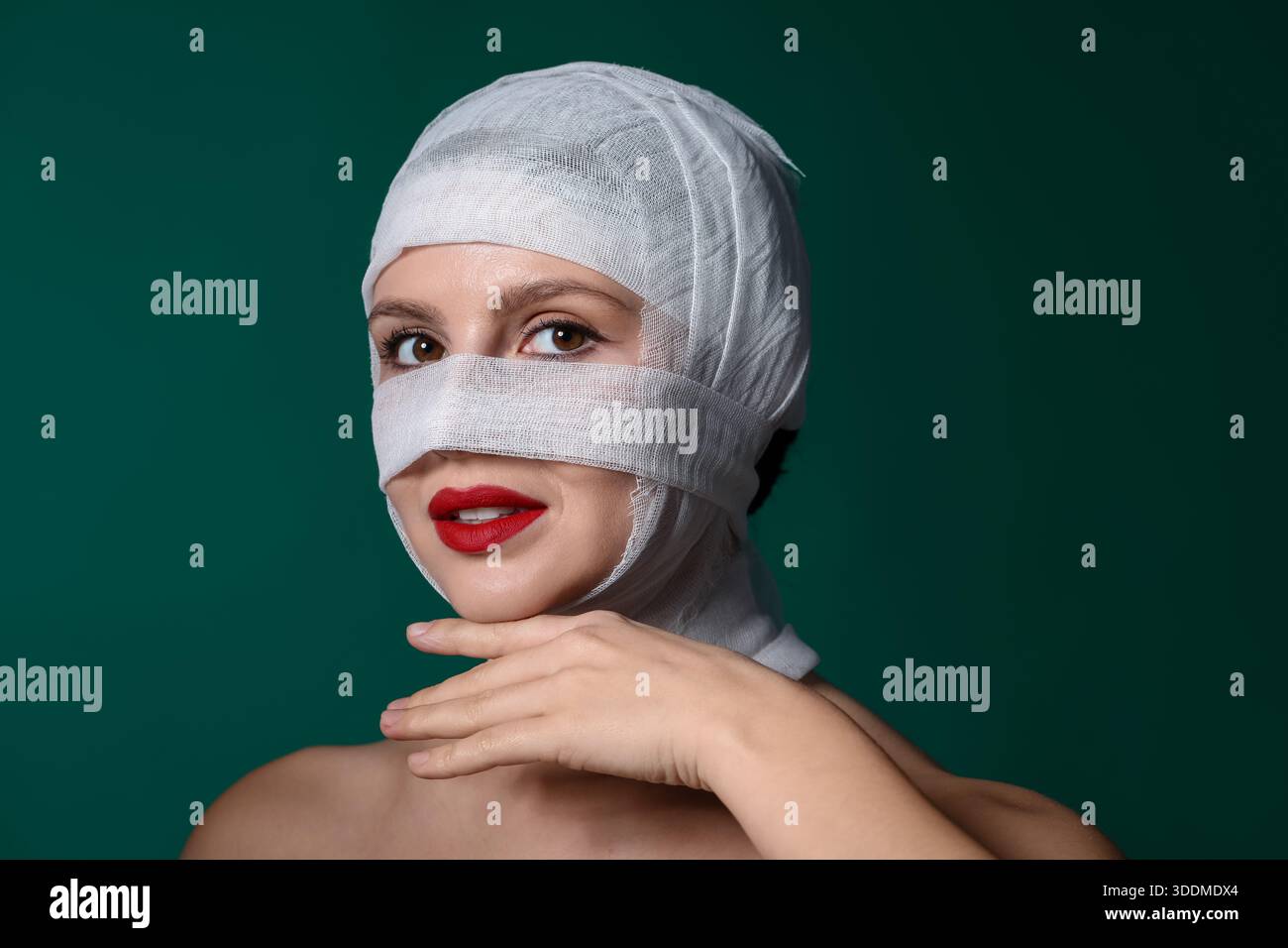 Woman with face wrapped in medical bandage after plastic surgery ...