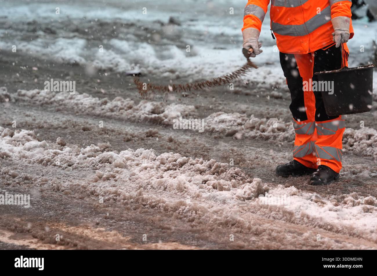 02 January 2026, Hamburg: An employee of the winter road clearance ...