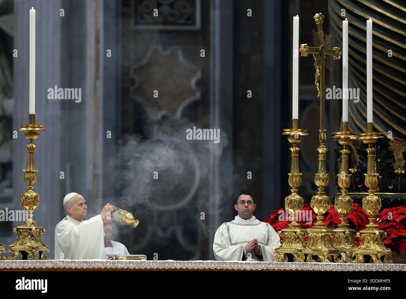 The pontiff blesses the crucifix on the central altar with incense ...