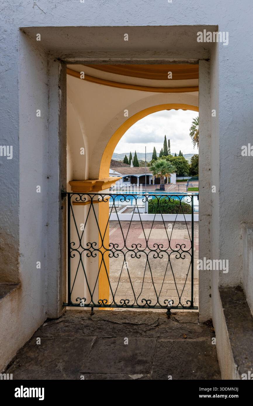 Historic whitewashed chapel and courtyard with arches and columns in ...