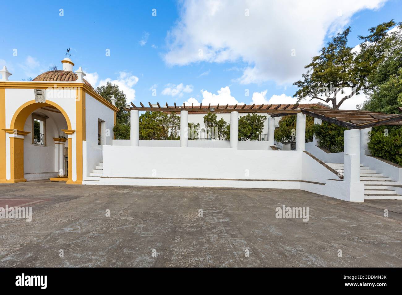 Historic whitewashed chapel and courtyard with arches and columns in ...