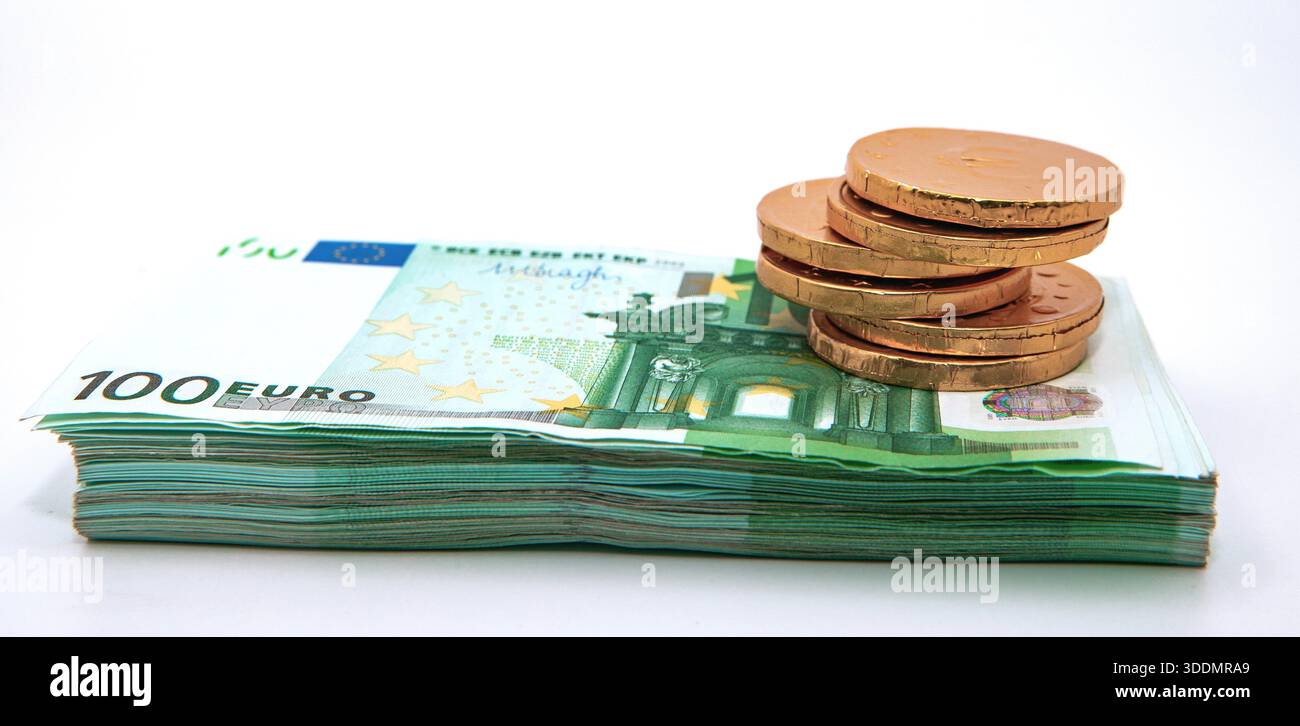 Stack of euro banknotes with gold coins on white background copy space ...
