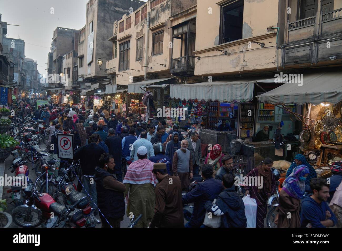 Local resident walks through a market it an old neighborhood of Lahore ...