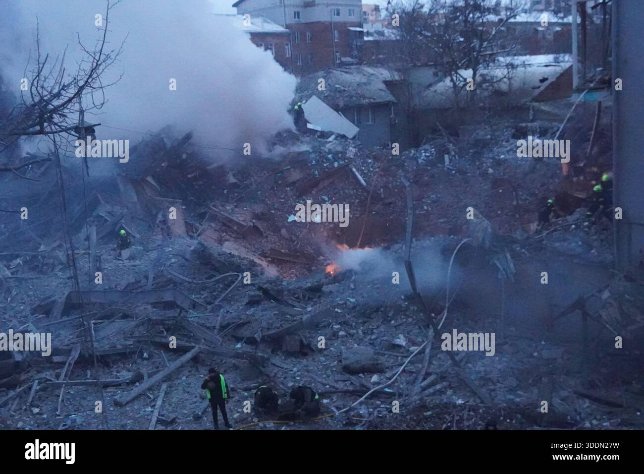 Emergency services personnel work to extinguish a fire following a ...