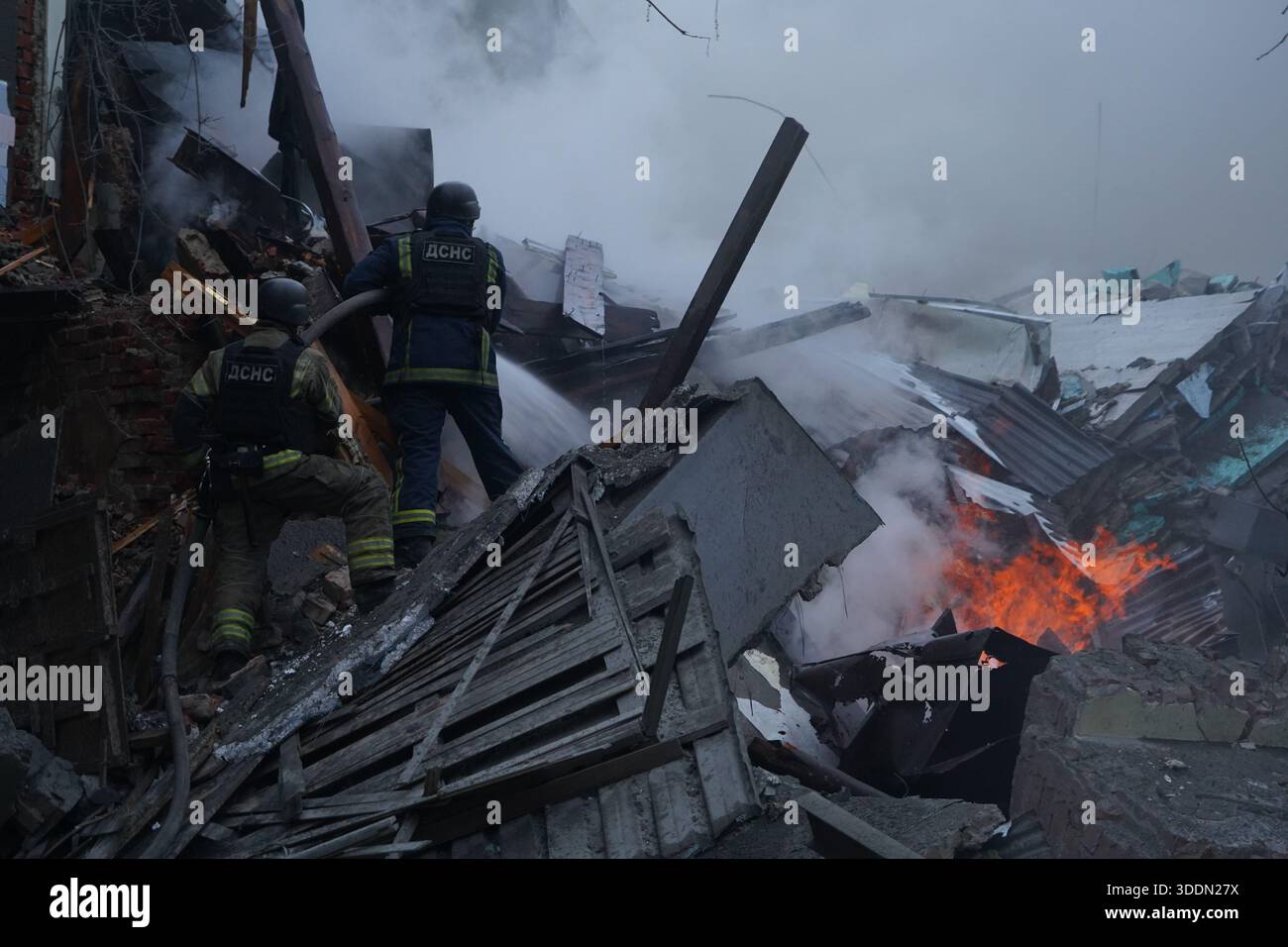 Emergency services personnel work to extinguish a fire following a ...
