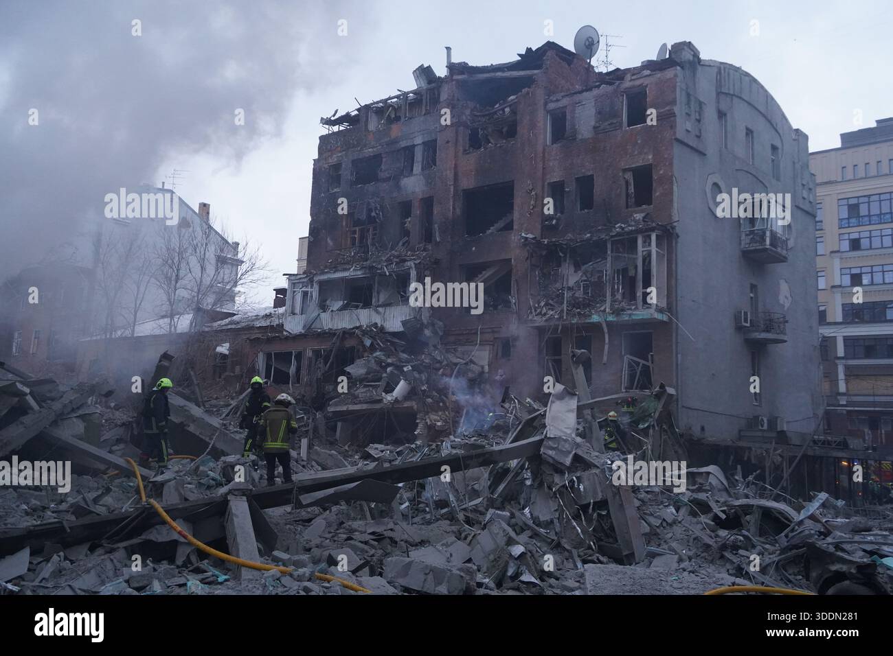 Emergency services personnel work to extinguish a fire following a ...