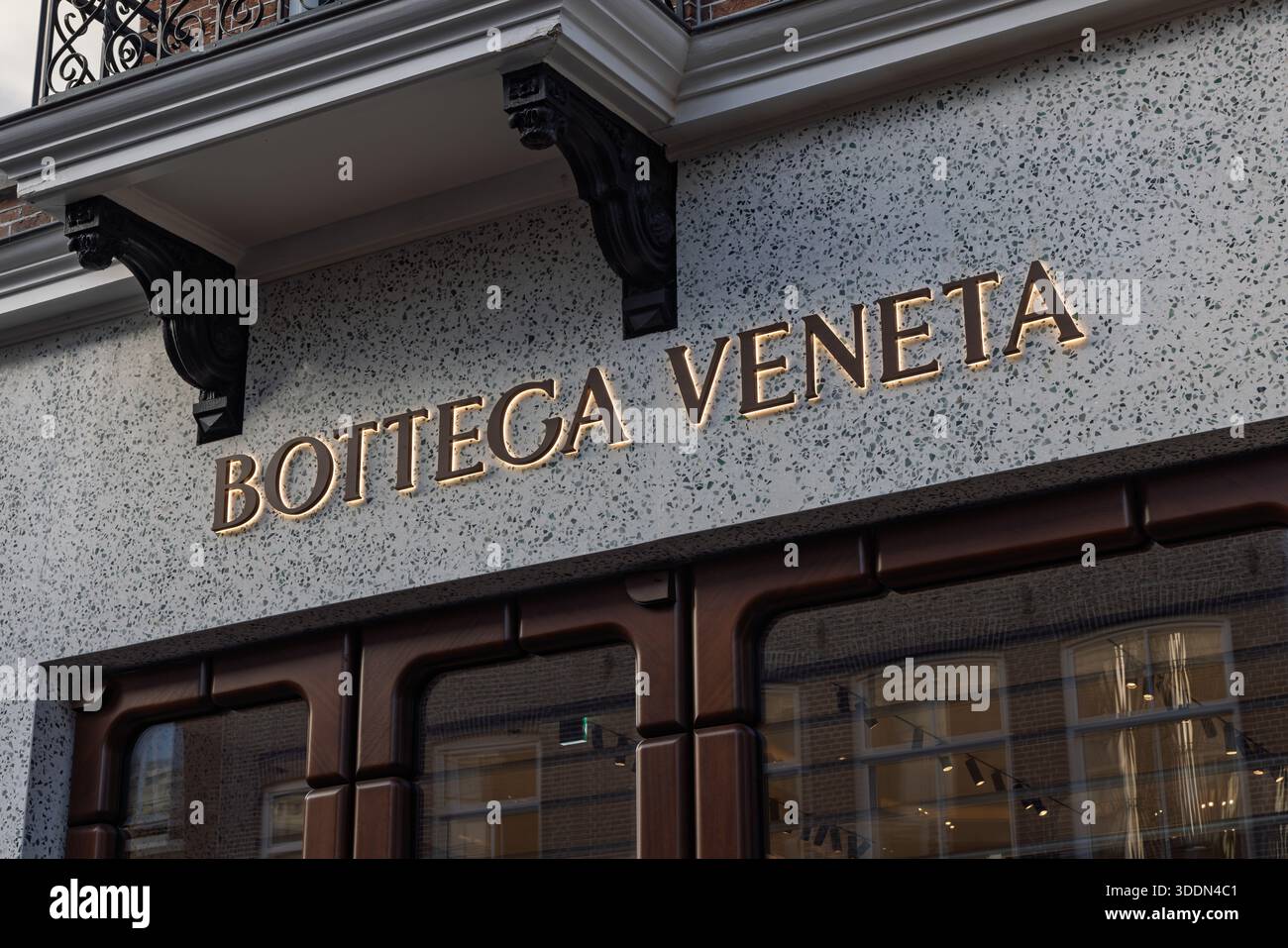 Close-up of the Bottega Veneta logo on a stone facade. Luxury Italian ...