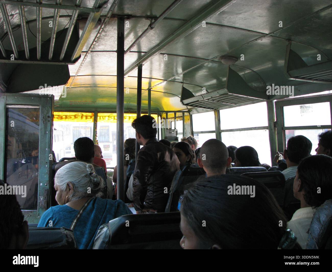 Crowded public bus interior with commuters during daily travel in India ...