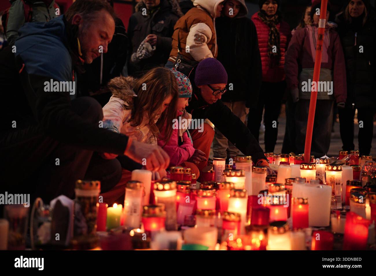 People lay flowers and candles near the Le Constellation bar, where a ...