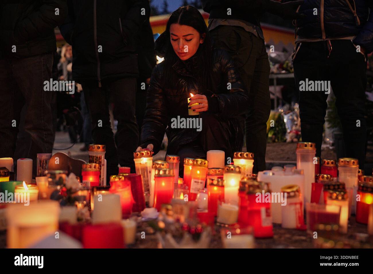 People lay flowers and candles near the Le Constellation bar, where a ...