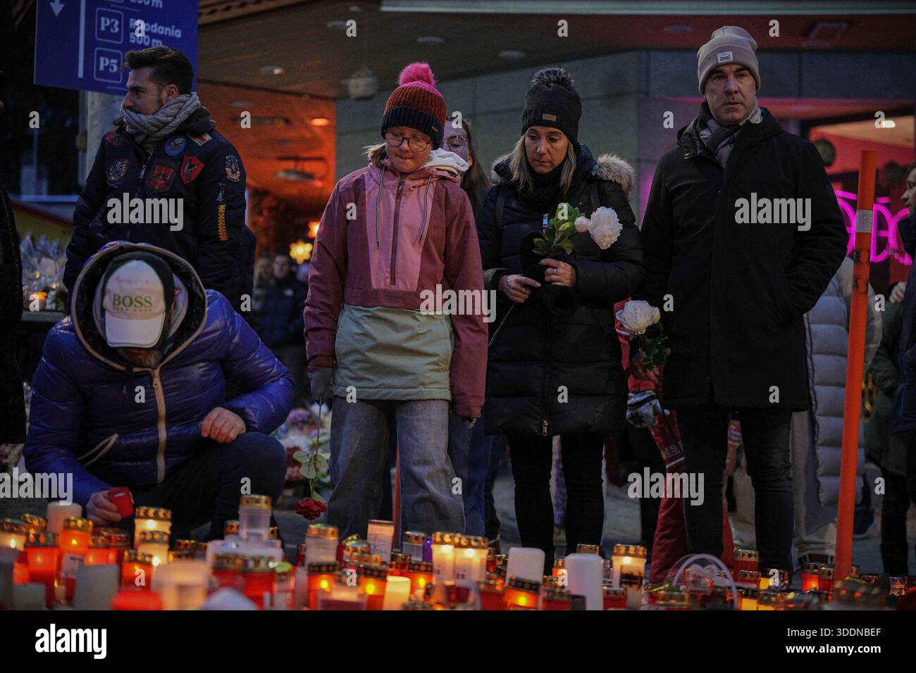 People lay flowers and candles near the Le Constellation bar, where a ...