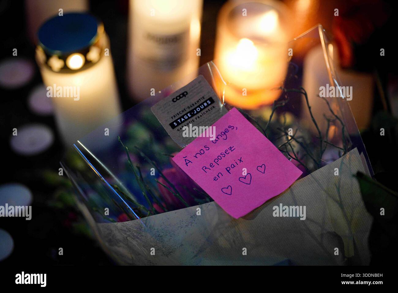 People lay flowers and candles near the Le Constellation bar, where a ...