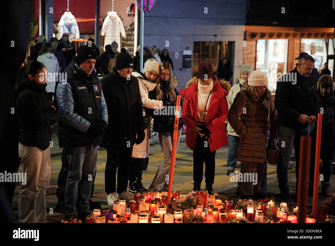 People lay flowers and candles near the Le Constellation bar, where a ...