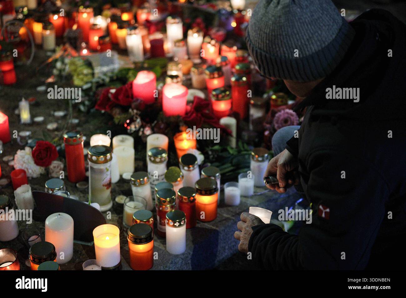 People lay flowers and candles near the Le Constellation bar, where a ...