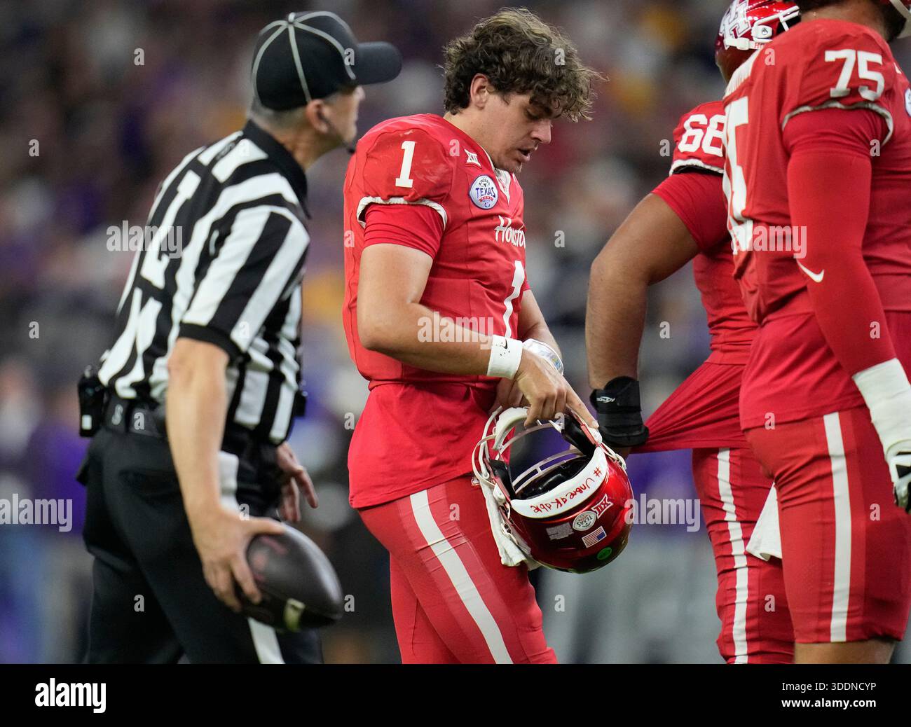 Houston quarterback Conner Weigman (1) puts his helmet back on after a ...