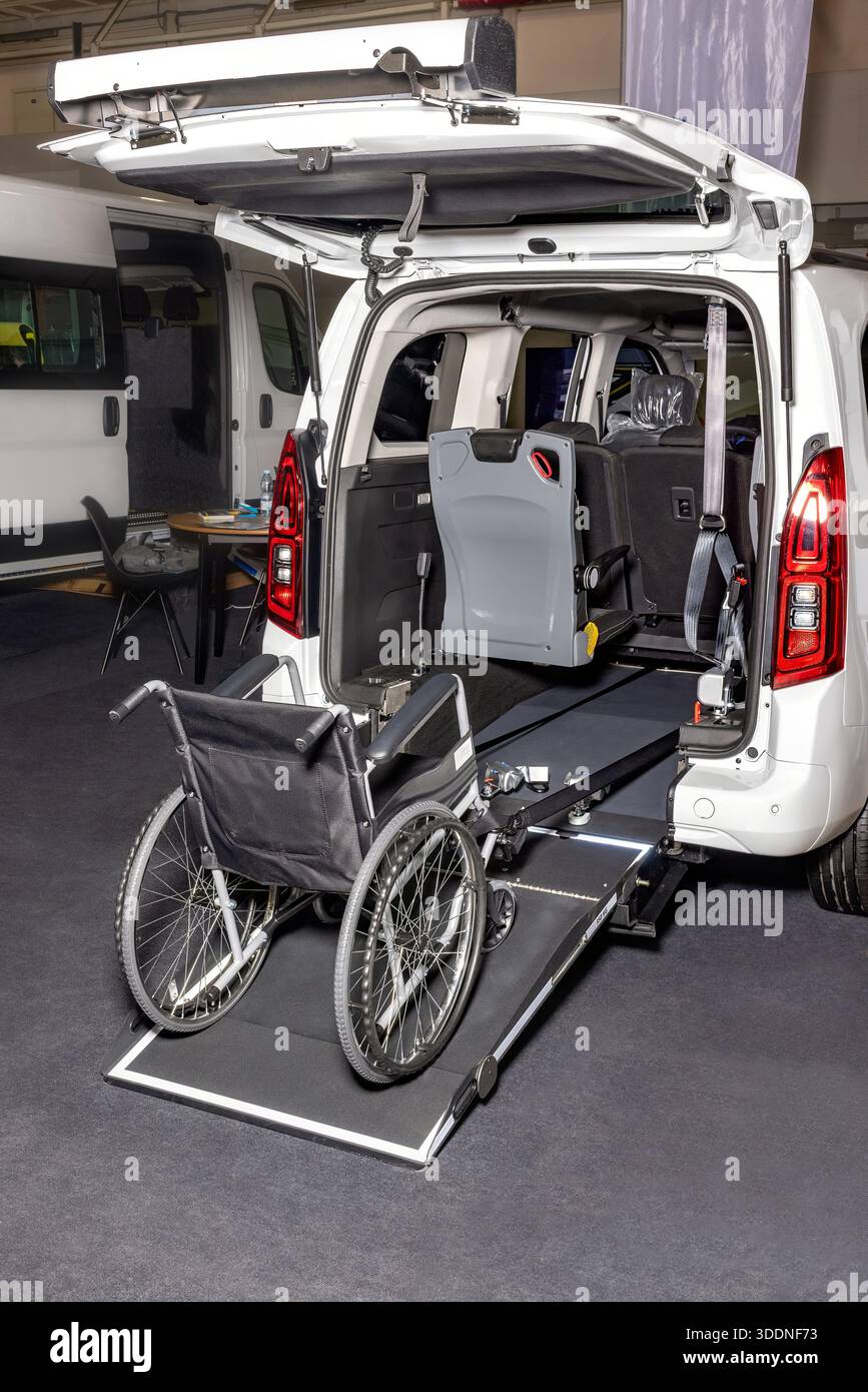 A modern wheelchair-accessible van showcases an efficient ramp system ...